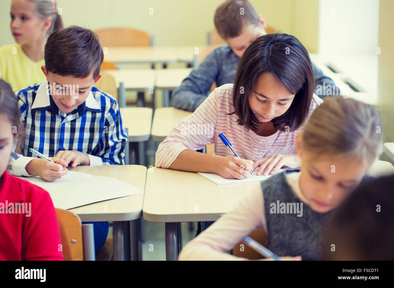 group of school kids writing test in classroom Stock Photo - Alamy