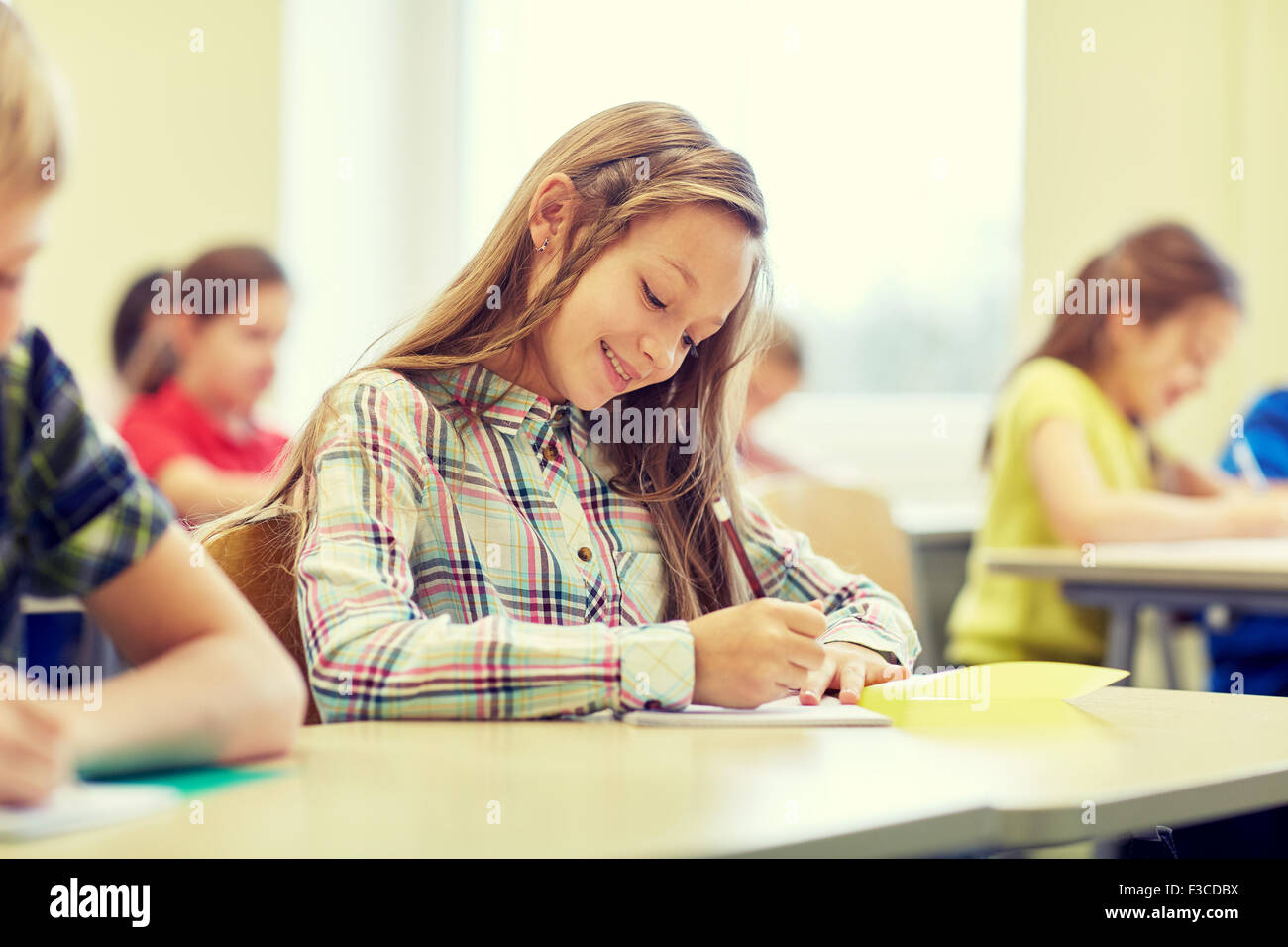 group of school kids writing test in classroom Stock Photo - Alamy
