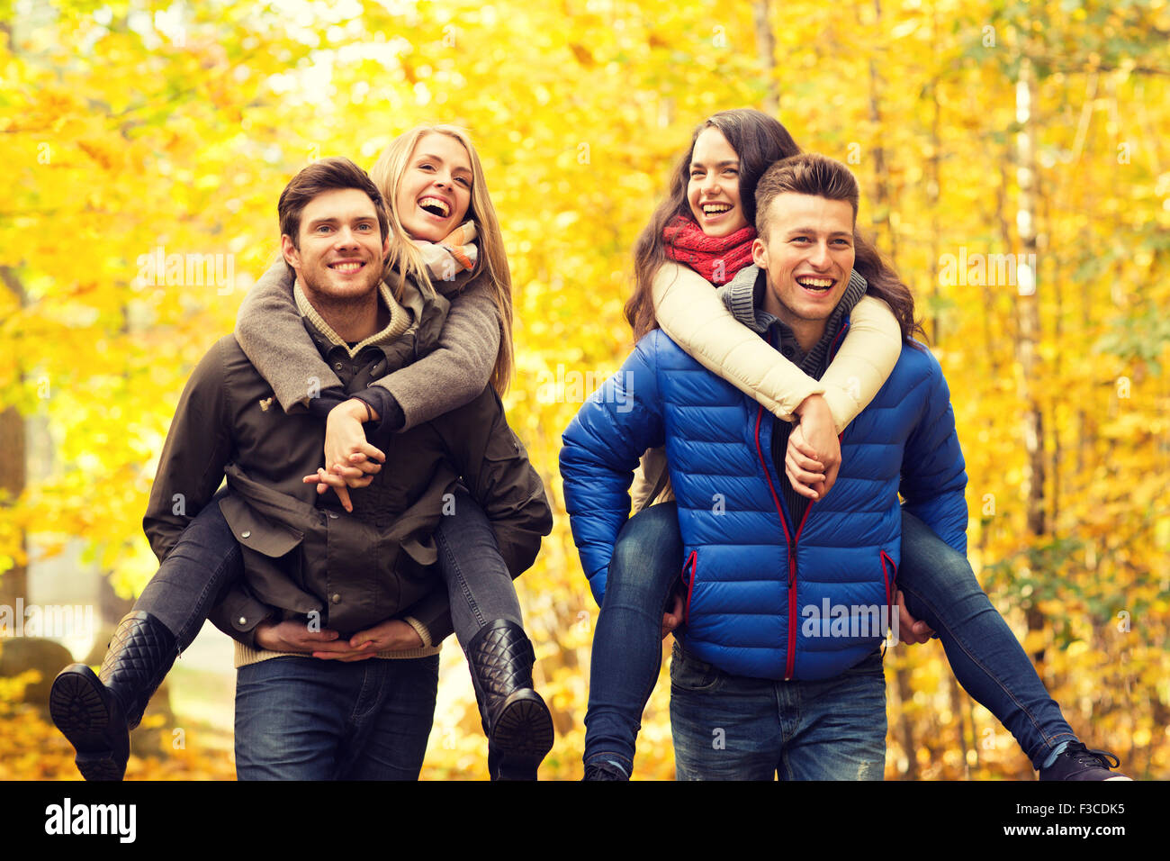 smiling friends having fun in autumn park Stock Photo - Alamy