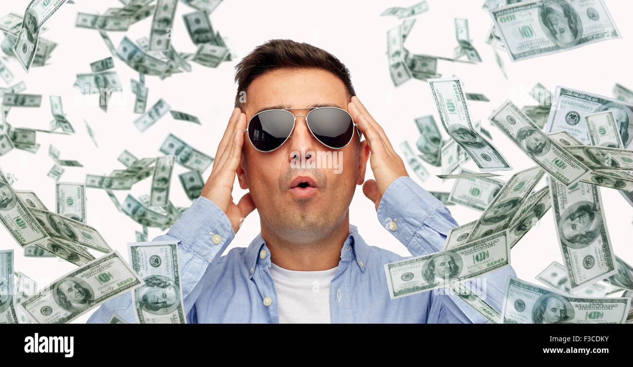 surprised man under dollar money rain Stock Photo - Alamy