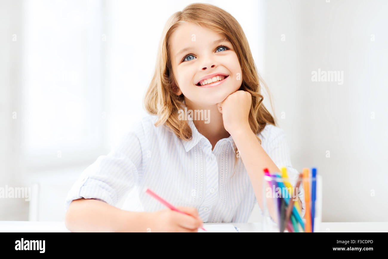 smiling little student girl drawing at school Stock Photo - Alamy