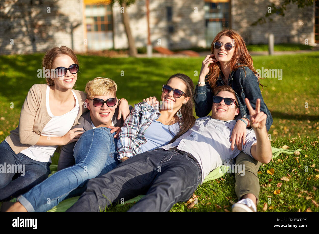 group of happy students showing victory gesture Stock Photo - Alamy