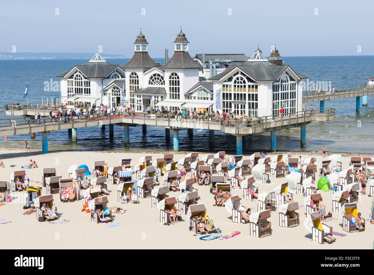 View of Pier and many traditional Strandkorb beach chairs on beach at ...