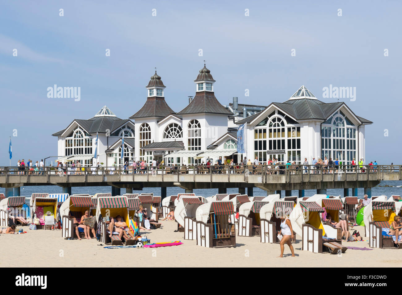 View of Pier and many traditional Strandkorb beach chairs on beach at ...