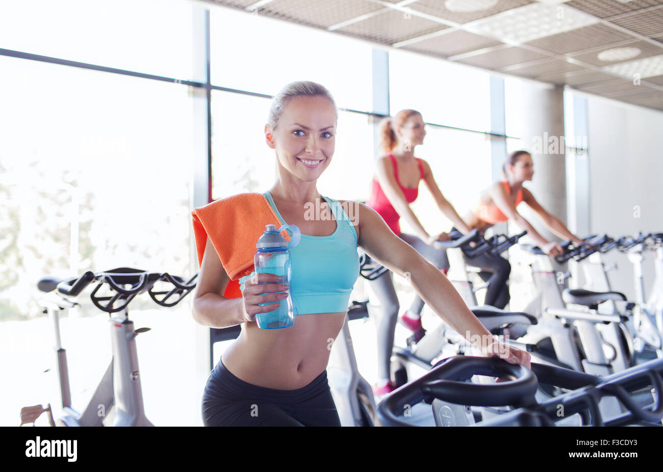 group of women riding on exercise bike in gym Stock Photo - Alamy