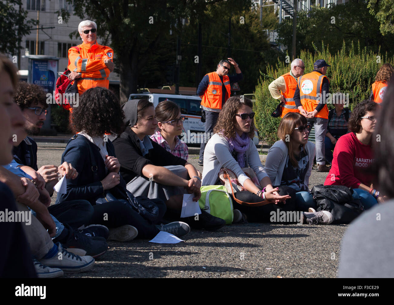 Students sitting on the ground during a march at the beginning of the ...