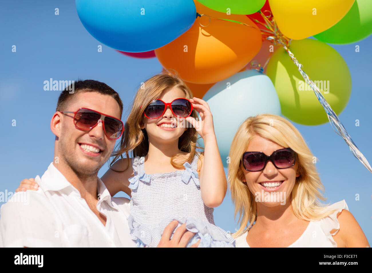 happy family with colorful balloons outdoors Stock Photo - Alamy
