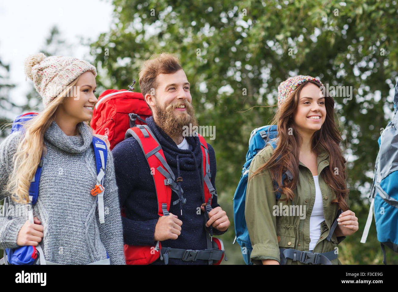 group of smiling friends with backpacks hiking Stock Photo - Alamy