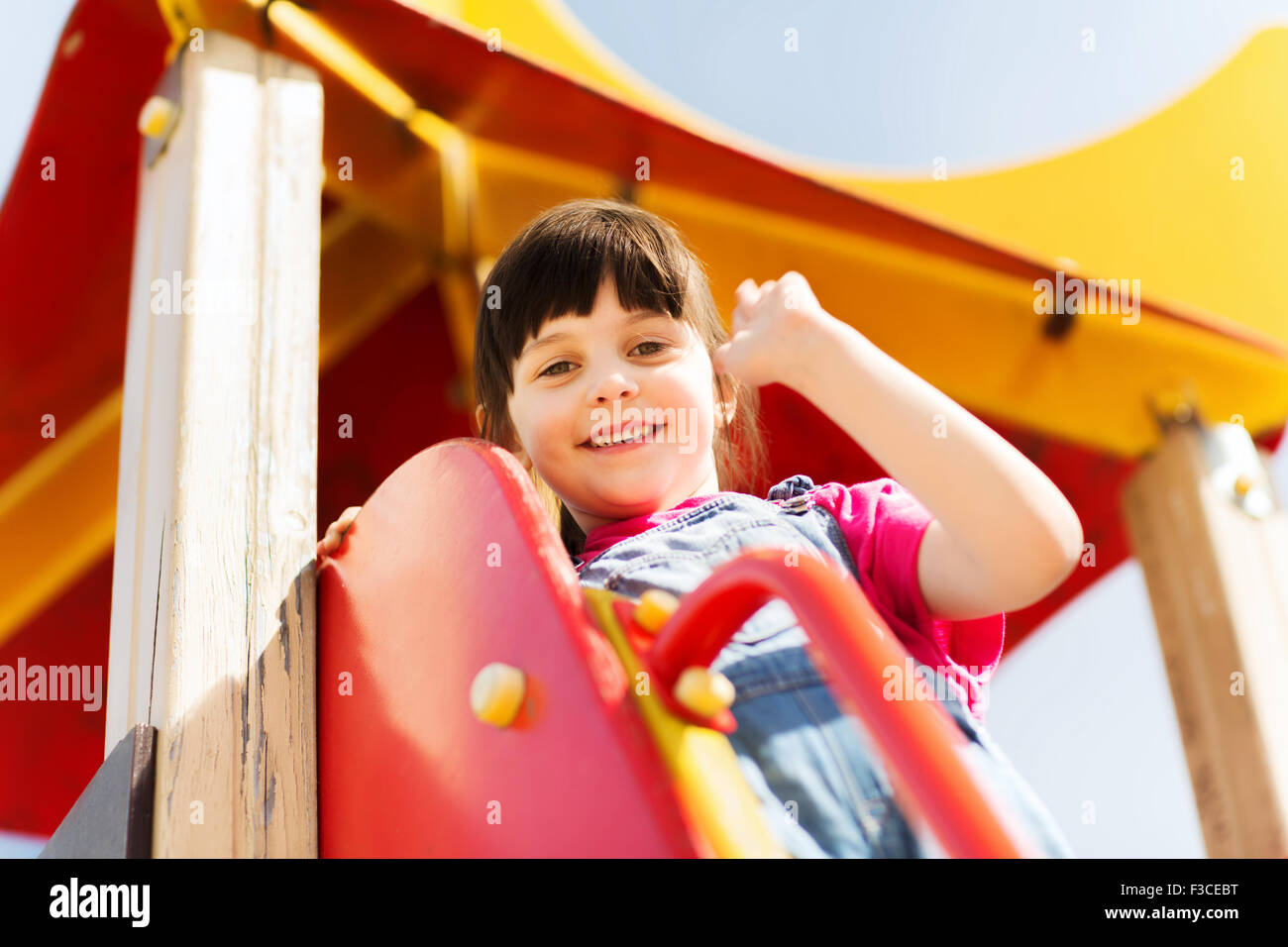 happy little girl climbing on children playground Stock Photo - Alamy