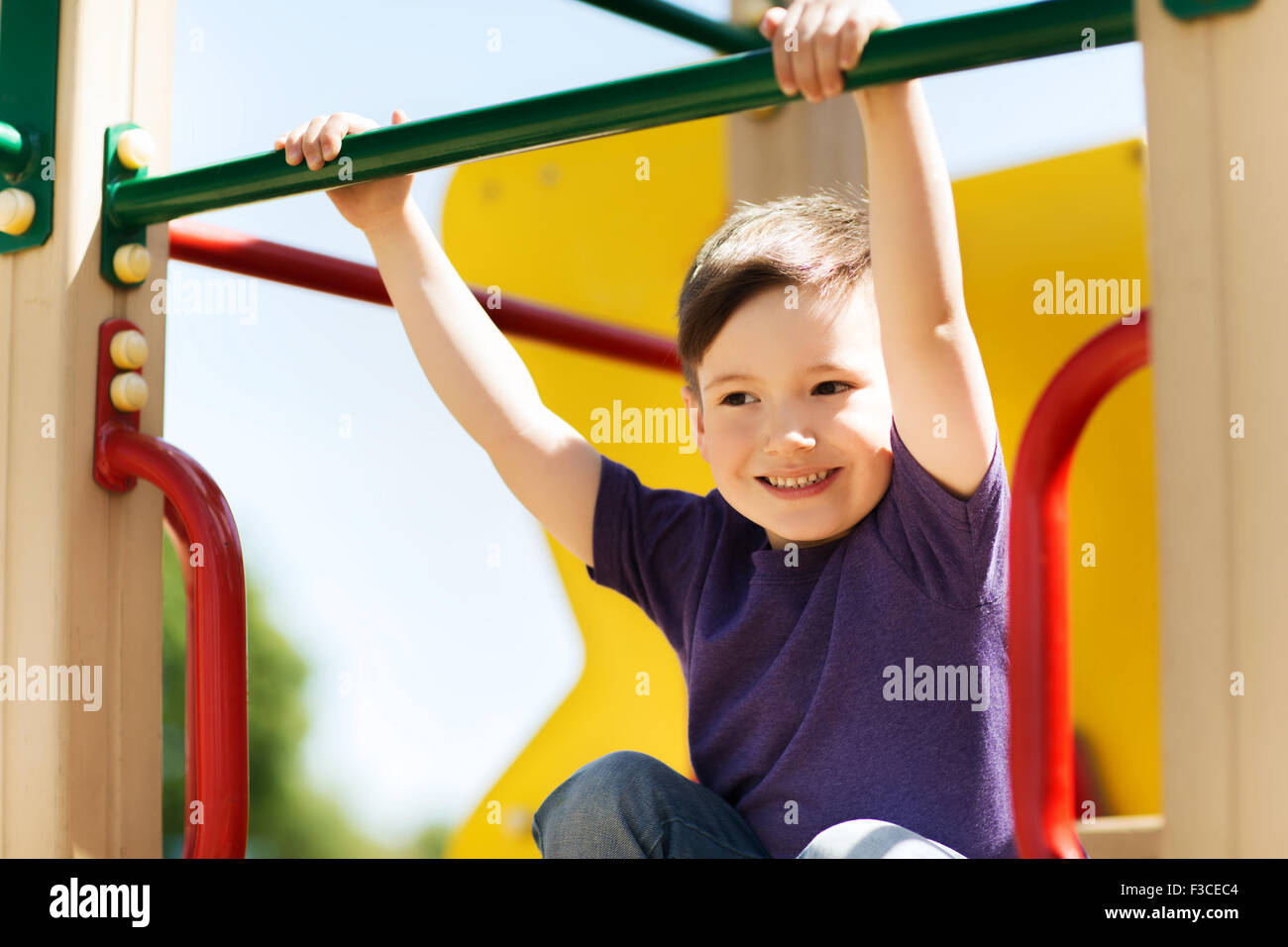 happy little boy climbing on children playground Stock Photo - Alamy