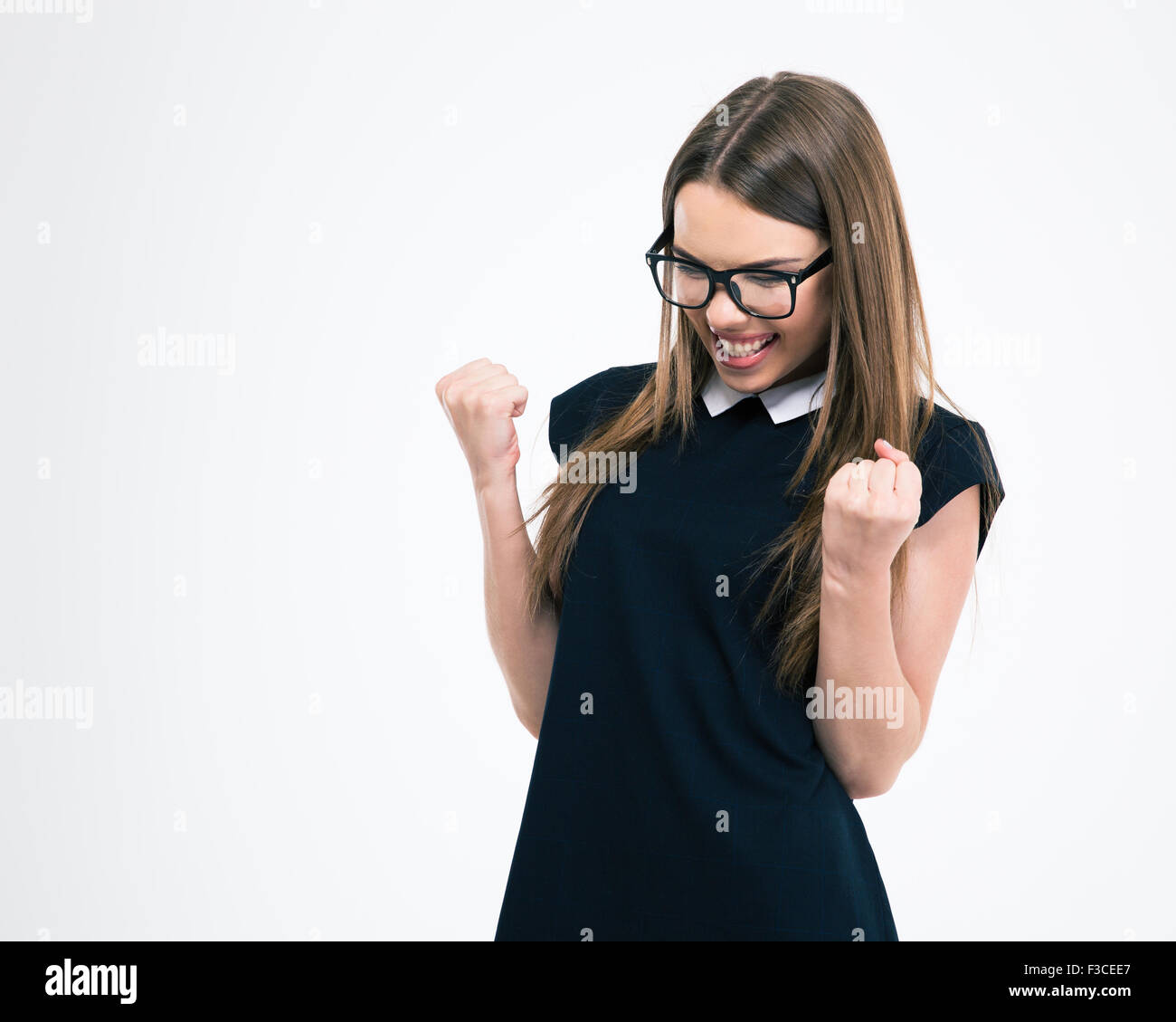 Portrait of a cheerful young girl celebrating her success isolated on a ...