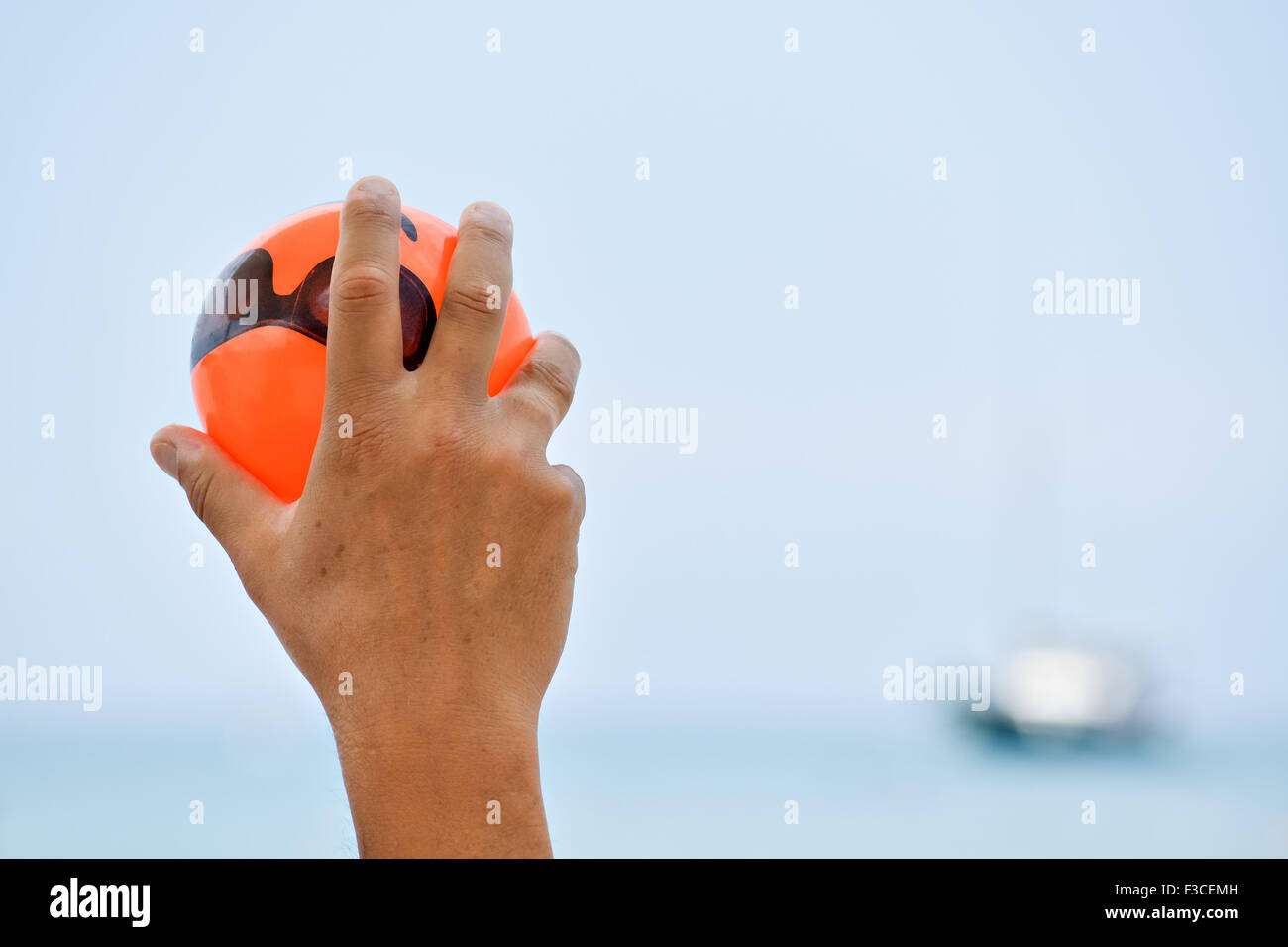Closeup of a hand holding small ball and playing a game in the water ...