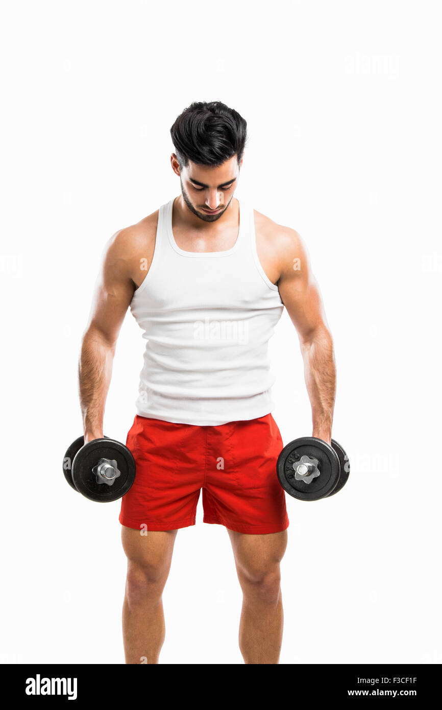 Portrait of handsome young man lifting weights, isolated on white ...