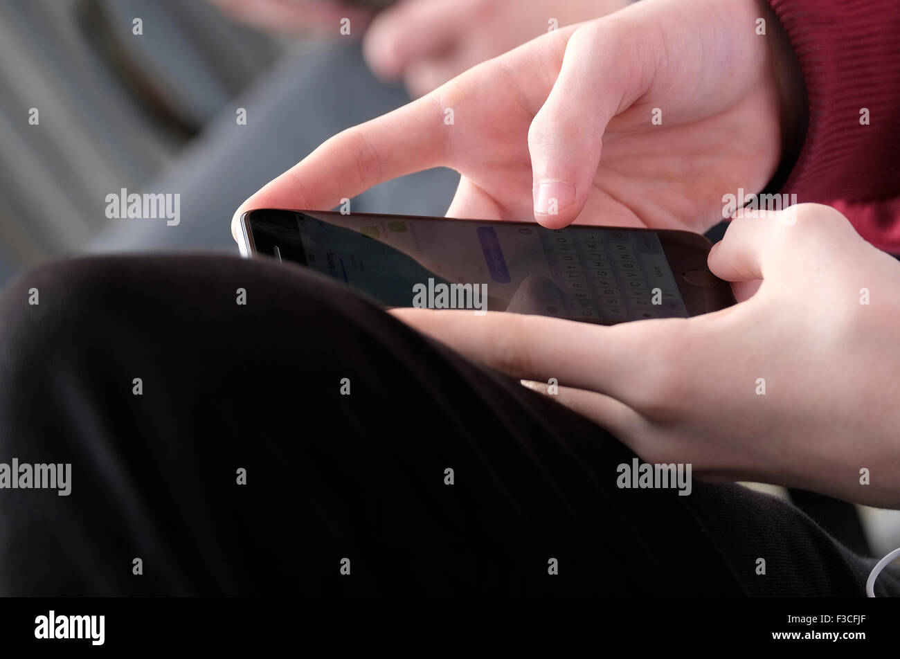 young male teenager using mobile phone Stock Photo - Alamy