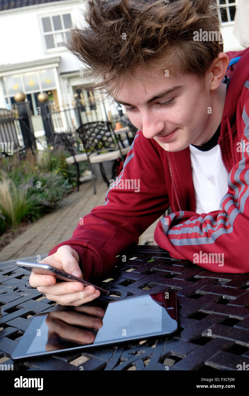 young male teenager using mobile phone Stock Photo - Alamy