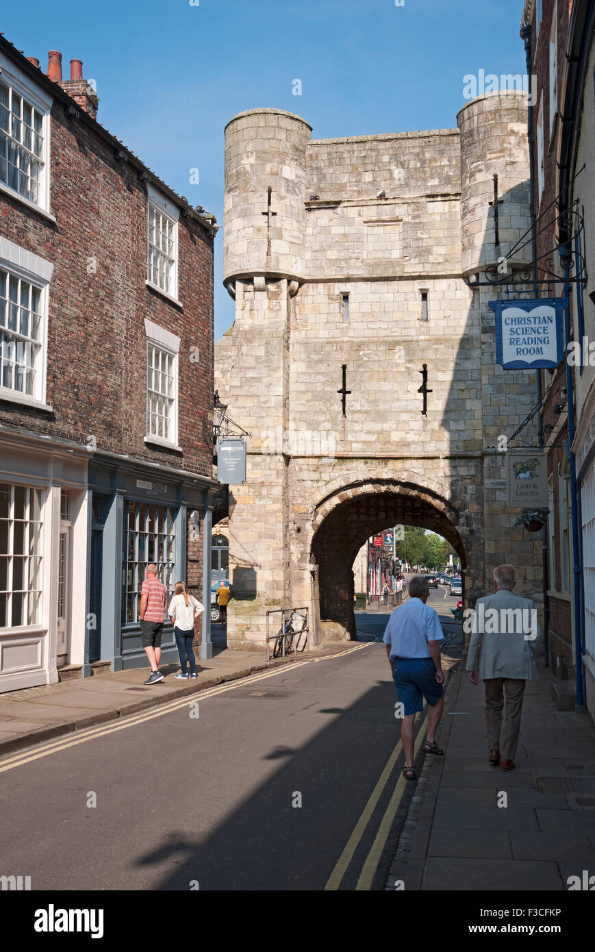 People visitors tourists walking along High Petergate in summer and ...