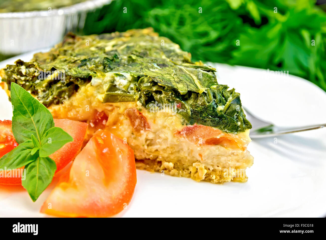 Pie celtic with spinach in dish on table Stock Photo - Alamy