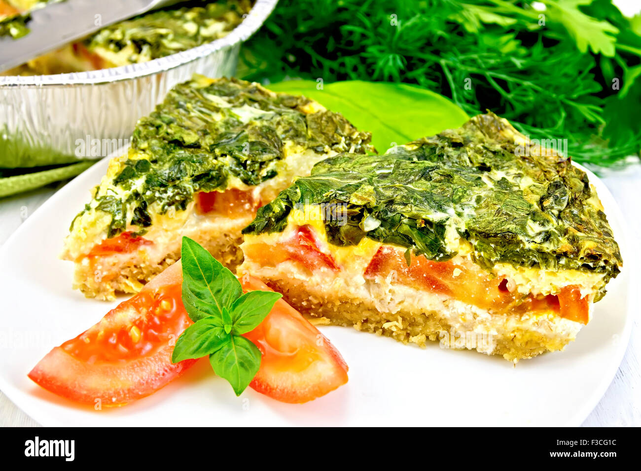 Pie celtic with spinach in plate on board Stock Photo - Alamy