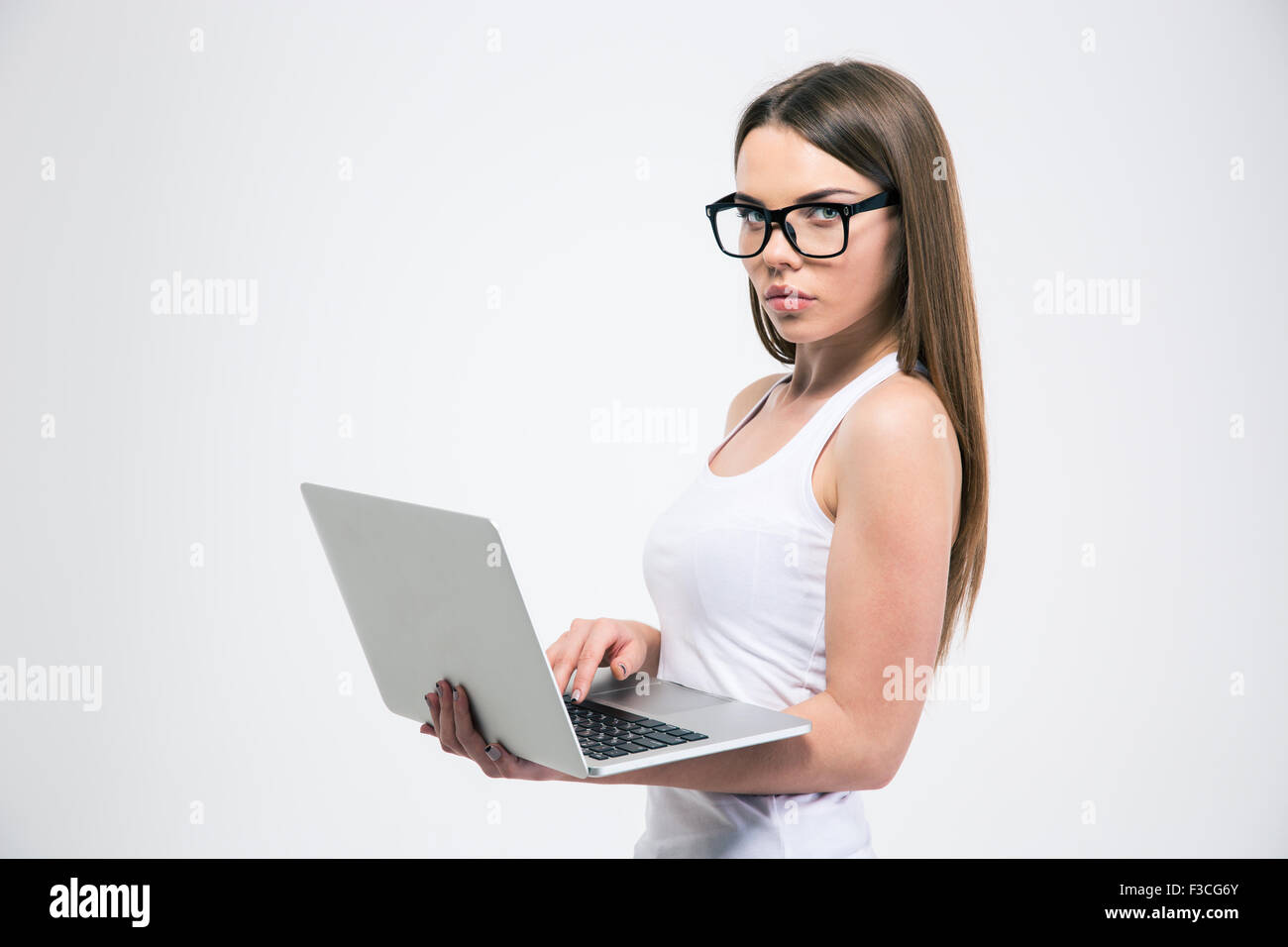 Portrait of a beautiful girl using laptop isolated on a white ...