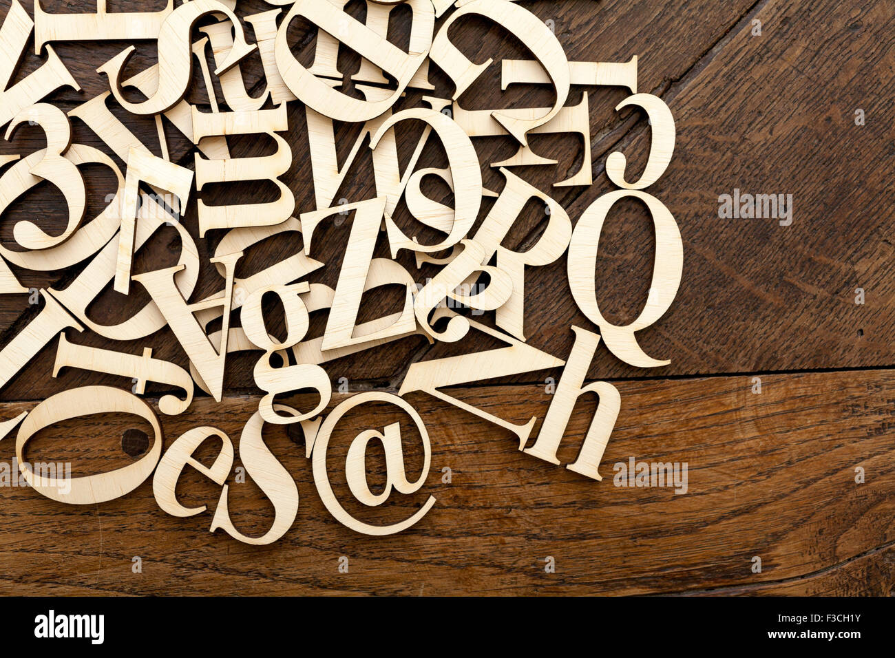 Wooden alphabet letters on old wooden surface with space for your own ...