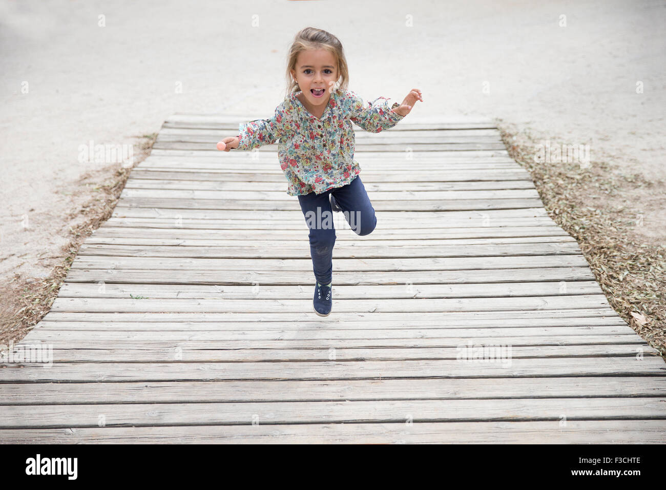 Four years girl jumping and playing Stock Photo - Alamy