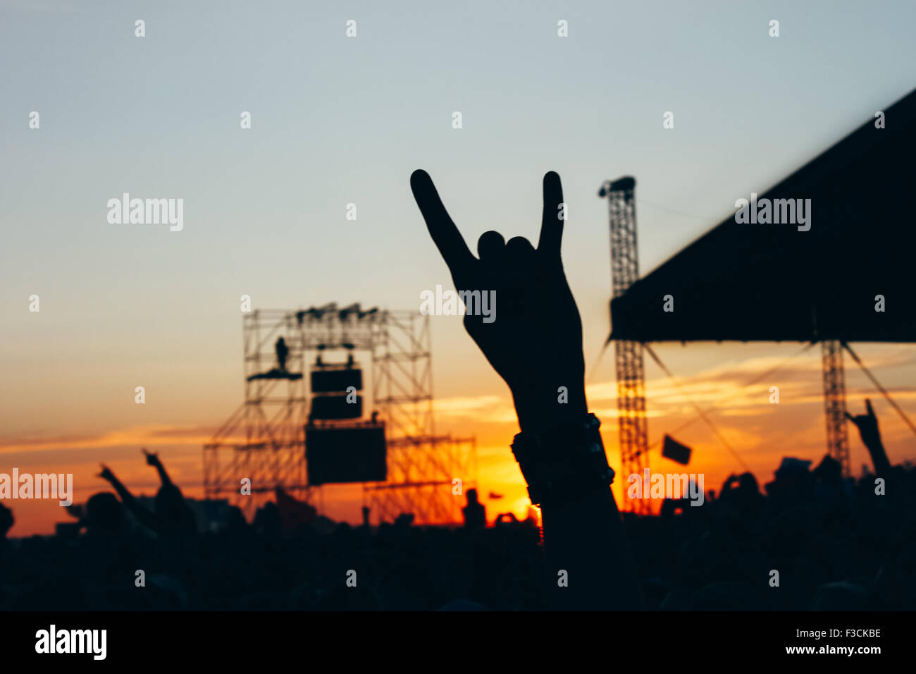 Rock concert, silhouettes of happy people raising up hands Stock Photo ...