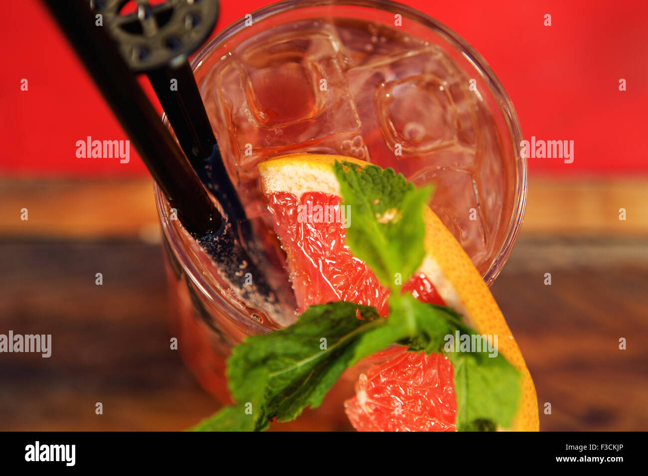 Top view fresh glass of red lemonade with mint and grapefruit on a wood ...