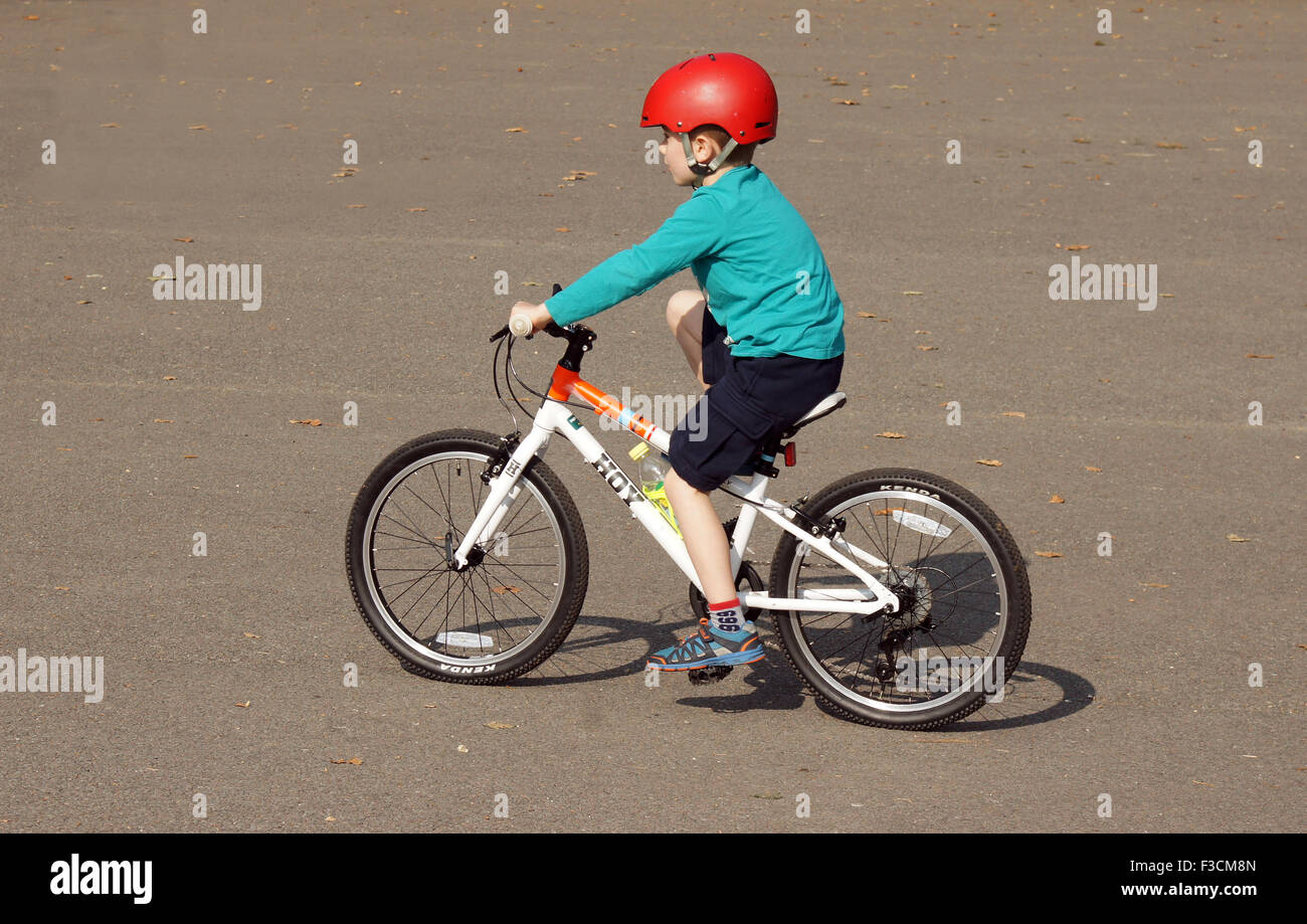 Young boy cycling in park Stock Photo - Alamy