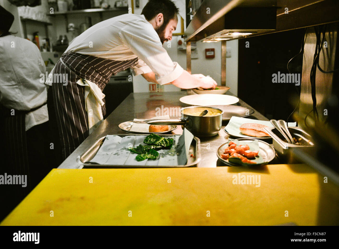Restaurant chef preparing dishes in kitchen Stock Photo - Alamy