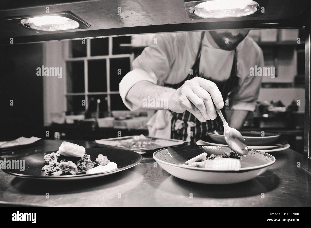 Restaurant chef preparing dish Stock Photo - Alamy