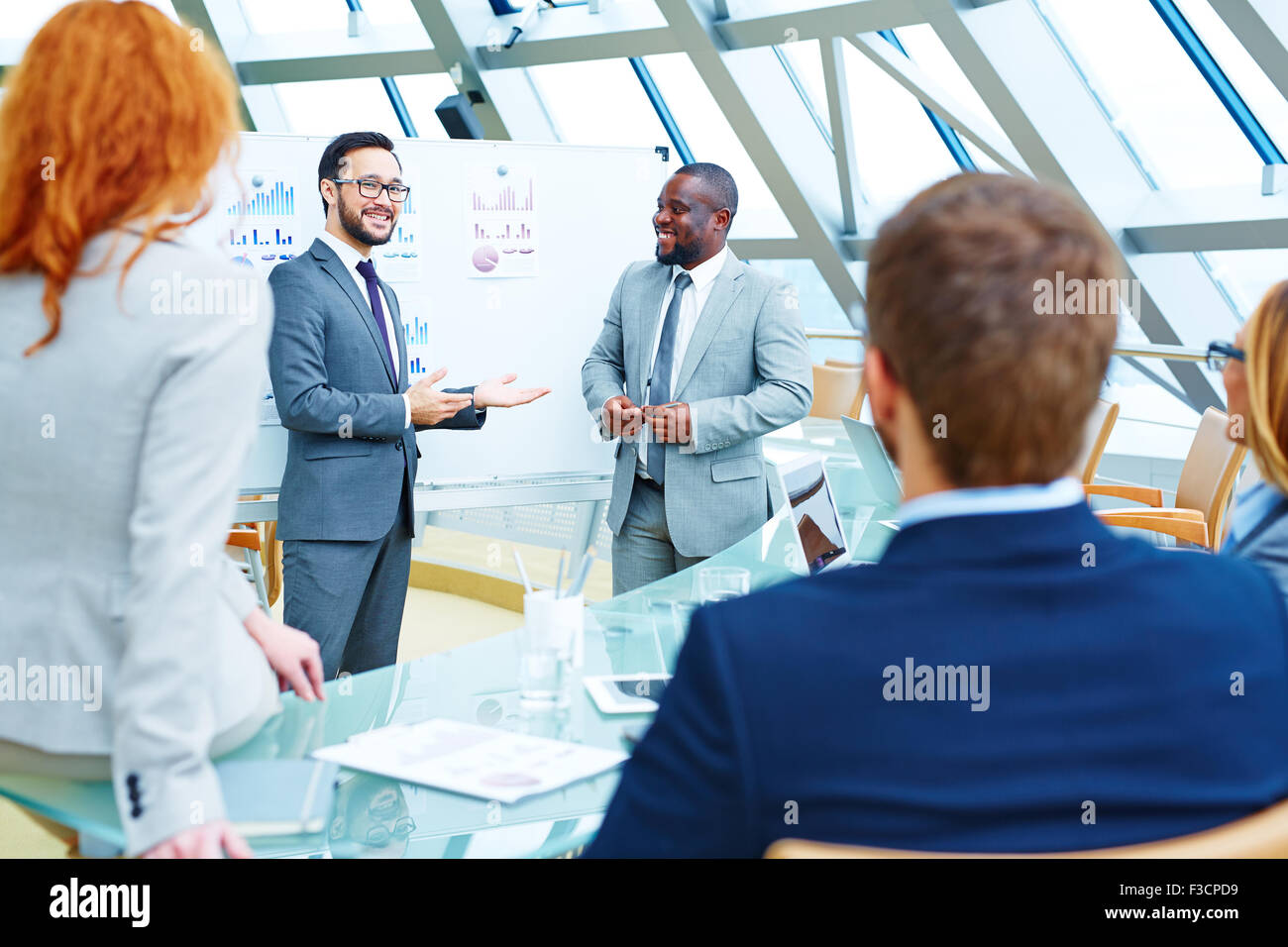 Asian businessman presenting colleagues their new business partner ...