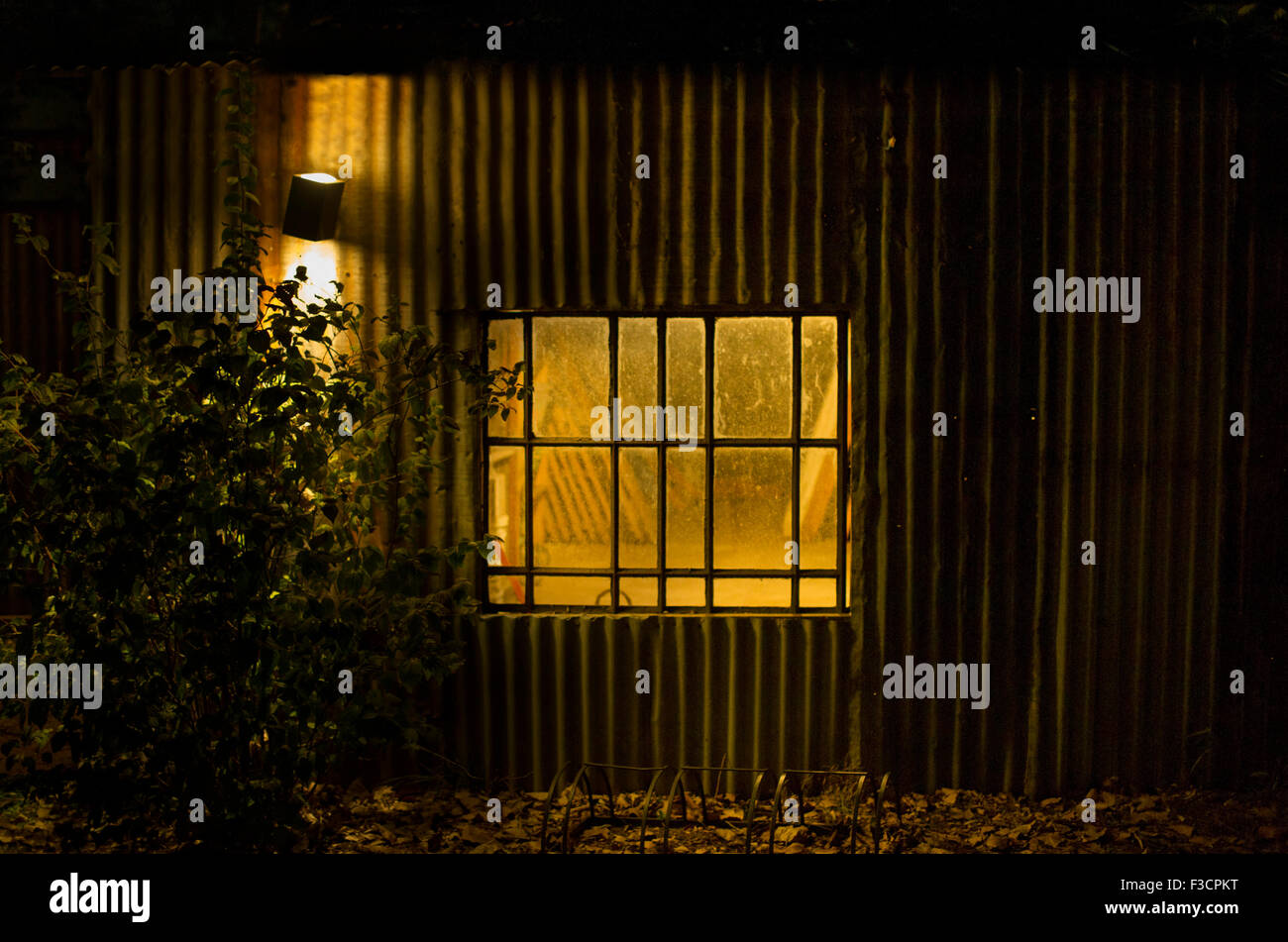 Window in shed illuminated at night Stock Photo - Alamy
