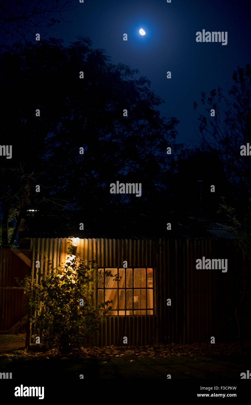 Shed illuminated on moonlit night Stock Photo - Alamy