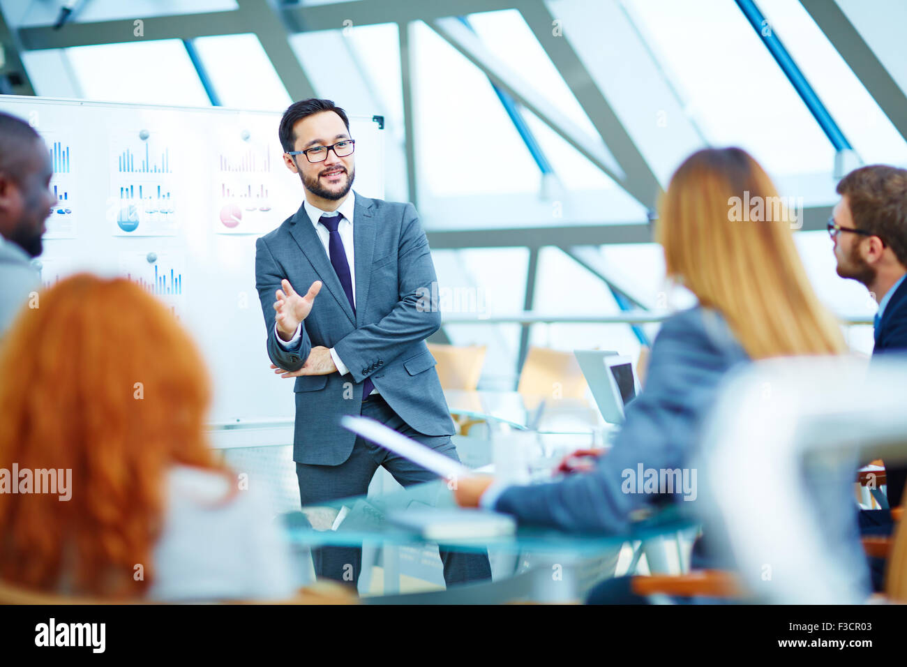 Asian businessman explaining his point of view to colleagues Stock ...