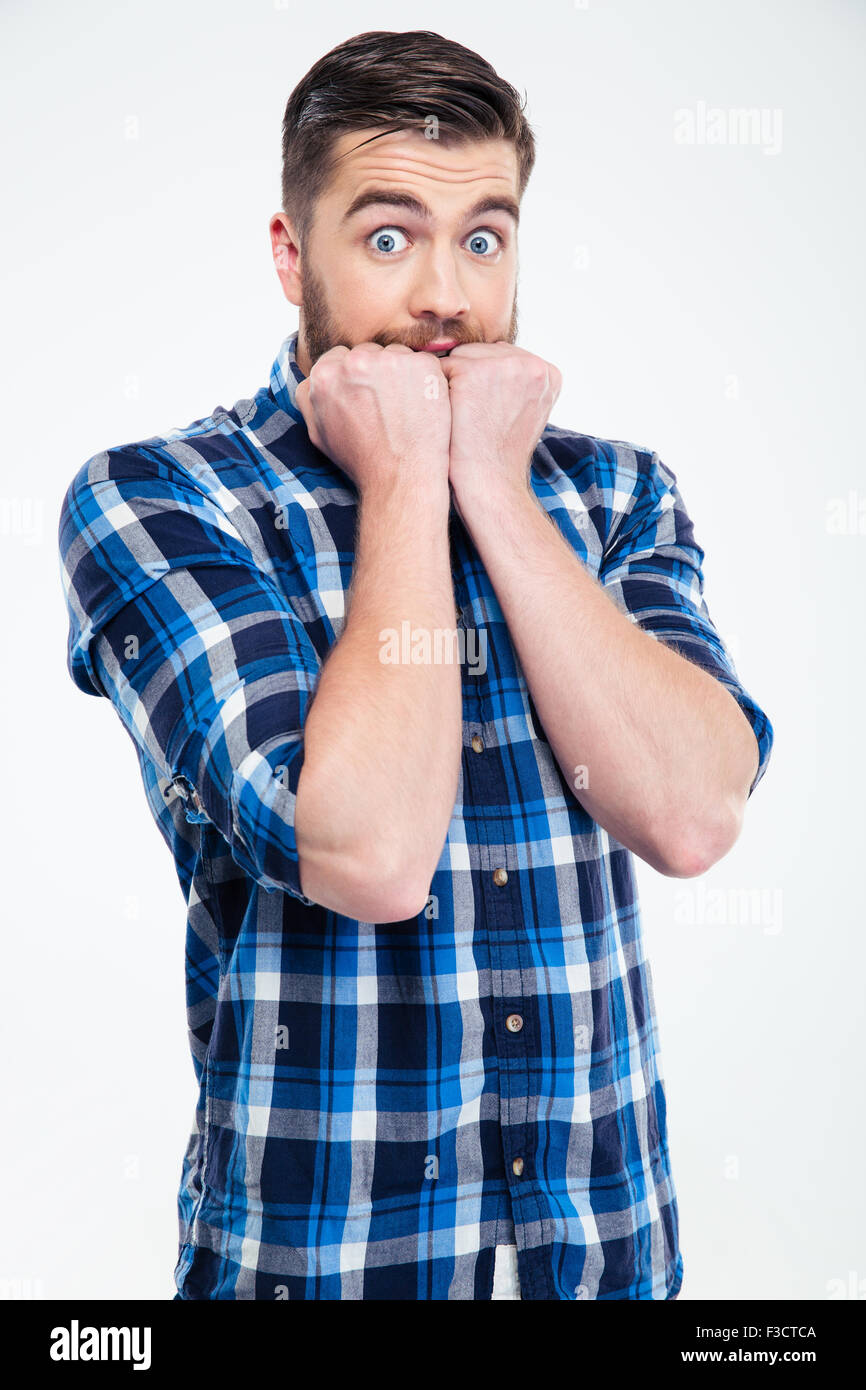Portrait of a scared casual man standing isolated on a white background ...