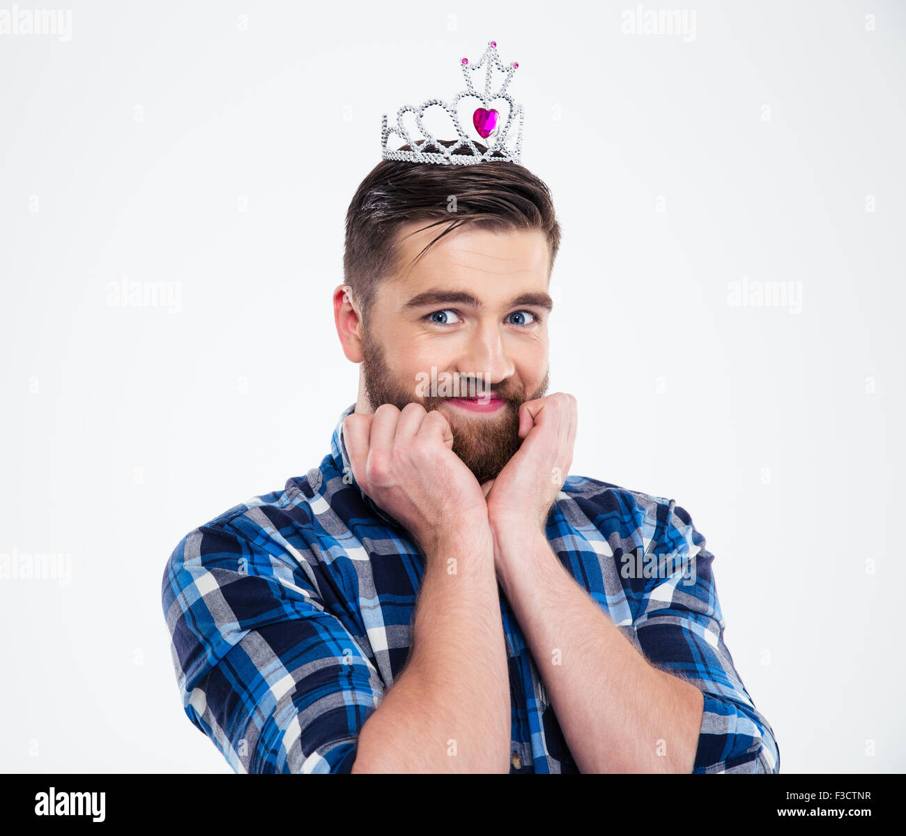 Portrait of a happy feminine man in queen crown standing isolated on a ...