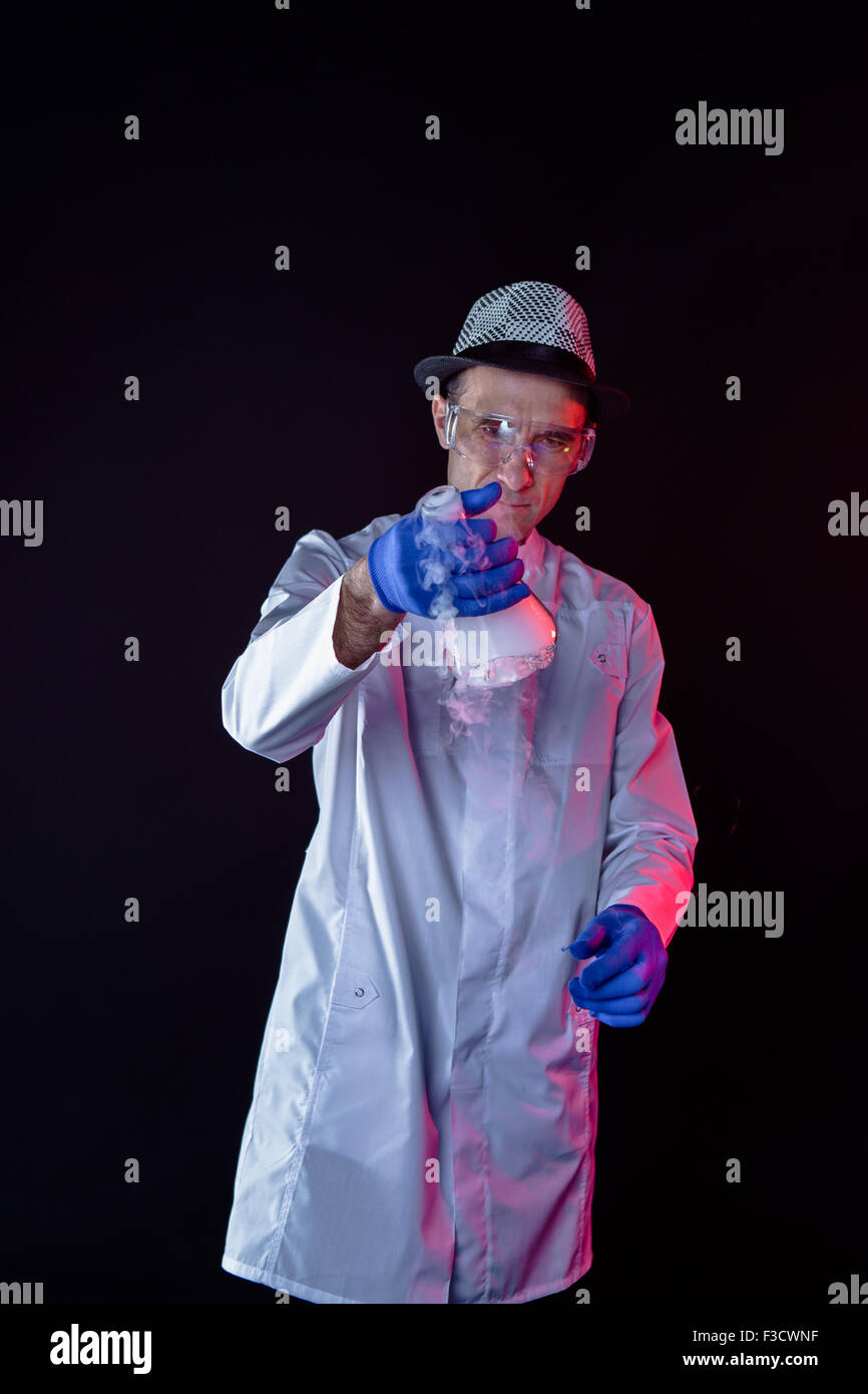 Smiling man scientist with dry ice Stock Photo - Alamy