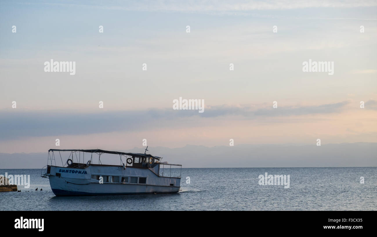 Boat on lake at sunset Stock Photo - Alamy