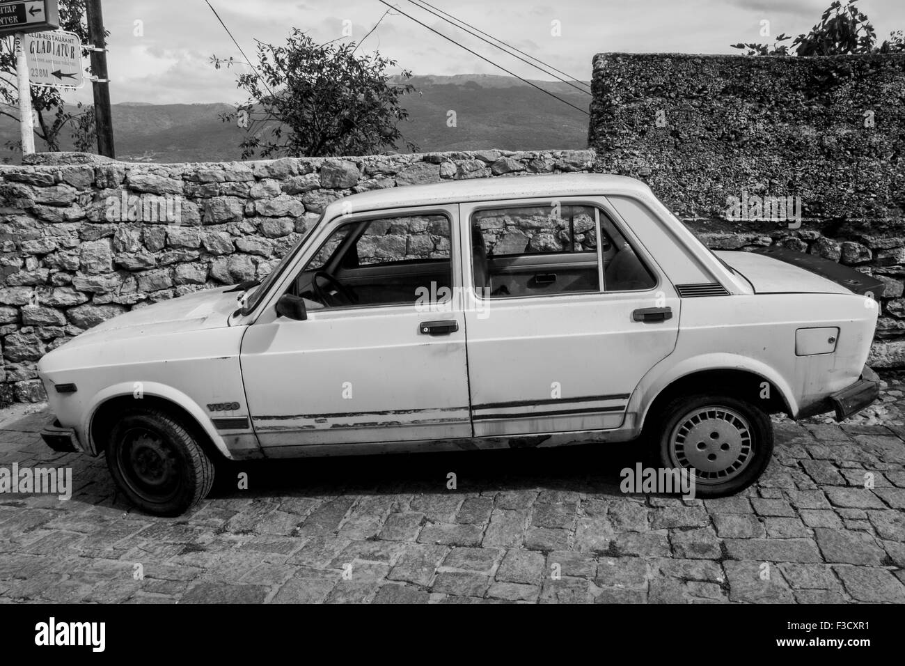 Old white car parked on Cobblestone road Stock Photo - Alamy