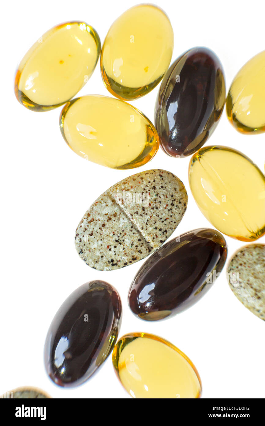 Different colored medicine and types of pills isolated on a white ...