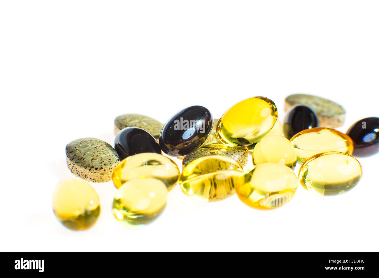 Different colored medicine and types of pills isolated on a white ...