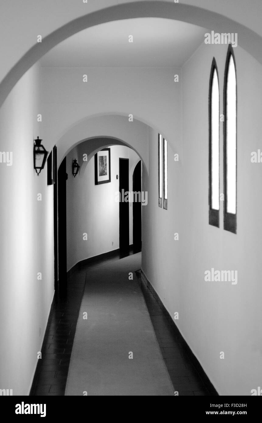 Classic hotel corridor with arch and arched windows. Black and White ...