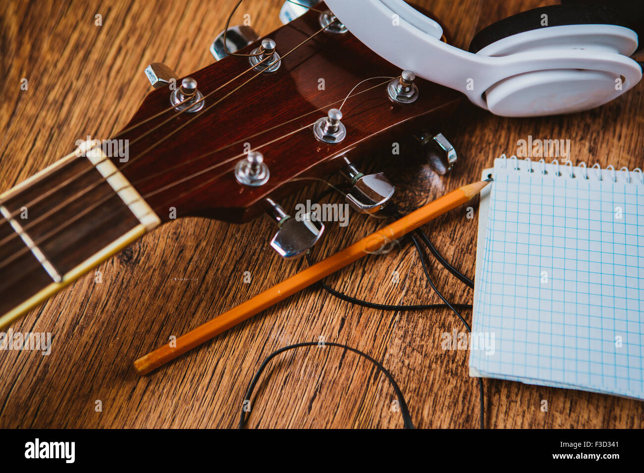 headphone guitar notebook and pencil Stock Photo - Alamy
