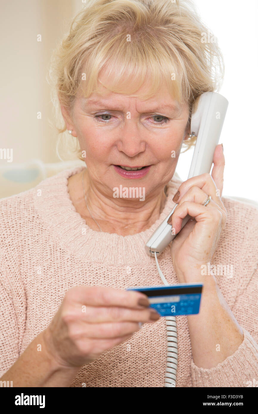 Senior Woman Giving Credit Card Details On The Phone Stock Photo - Alamy