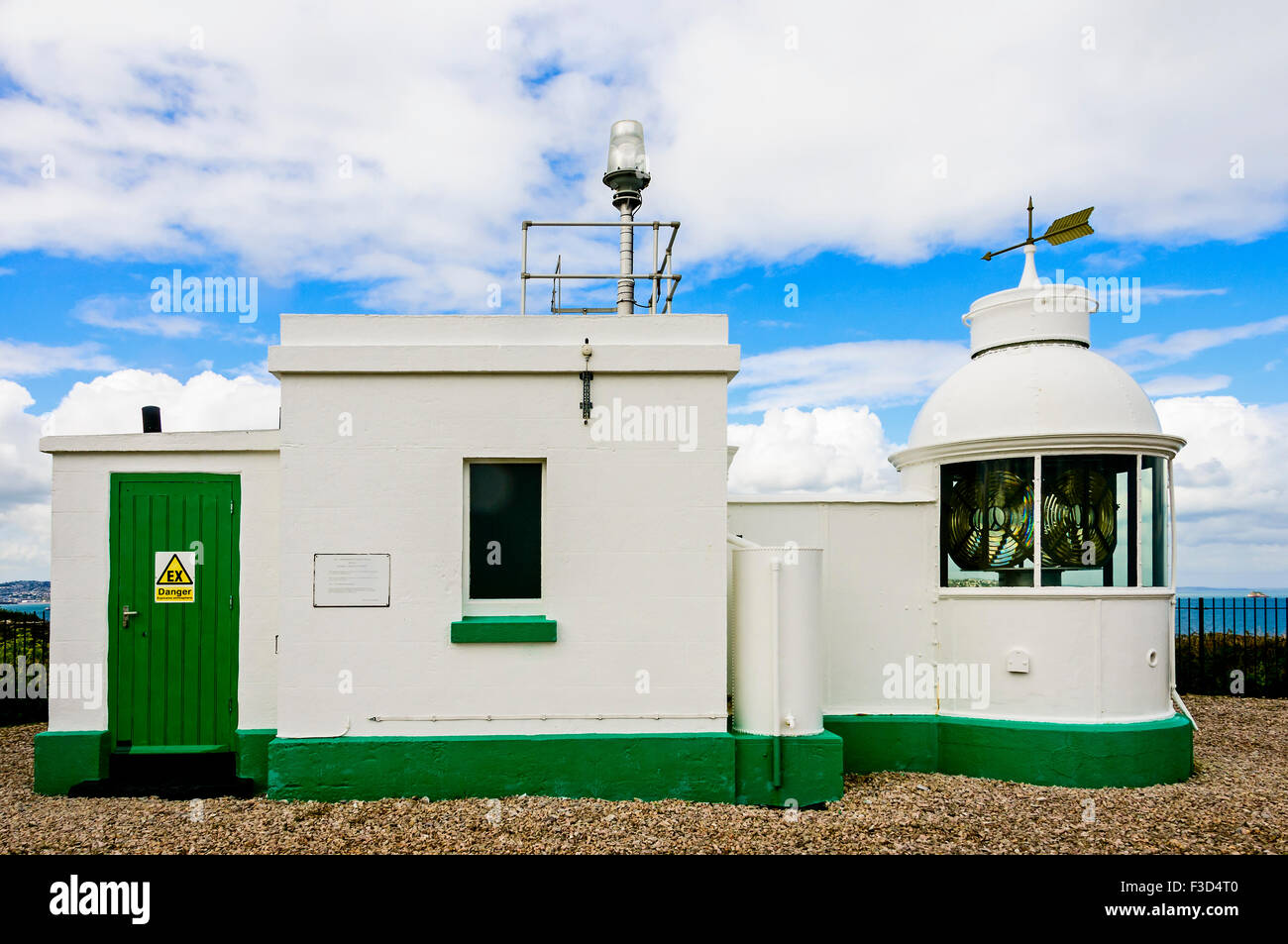 The white and green painted small lighthouse at the end of Berry Head ...
