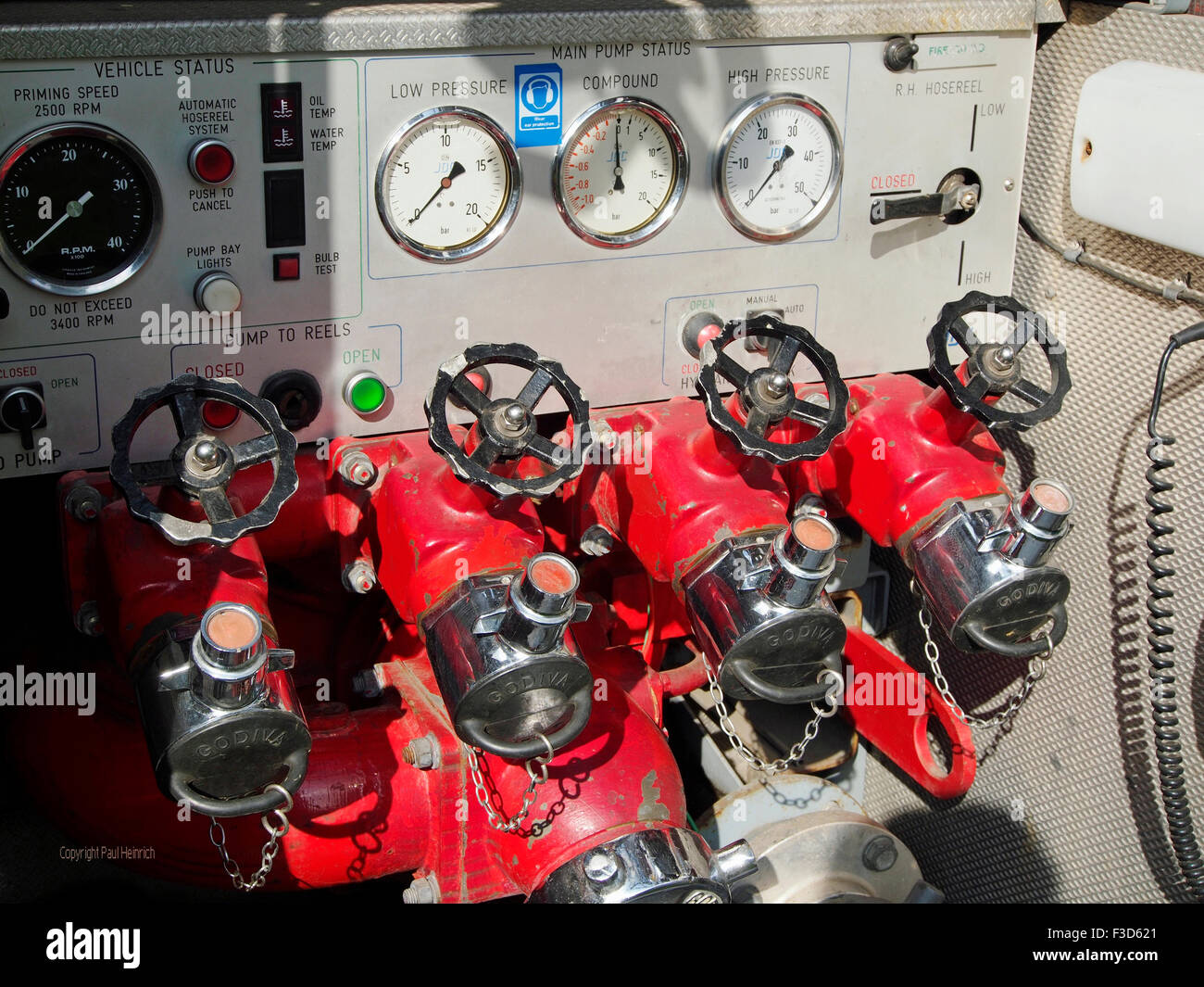 Rear of a fire engine showing the water pump outlets and hose ...