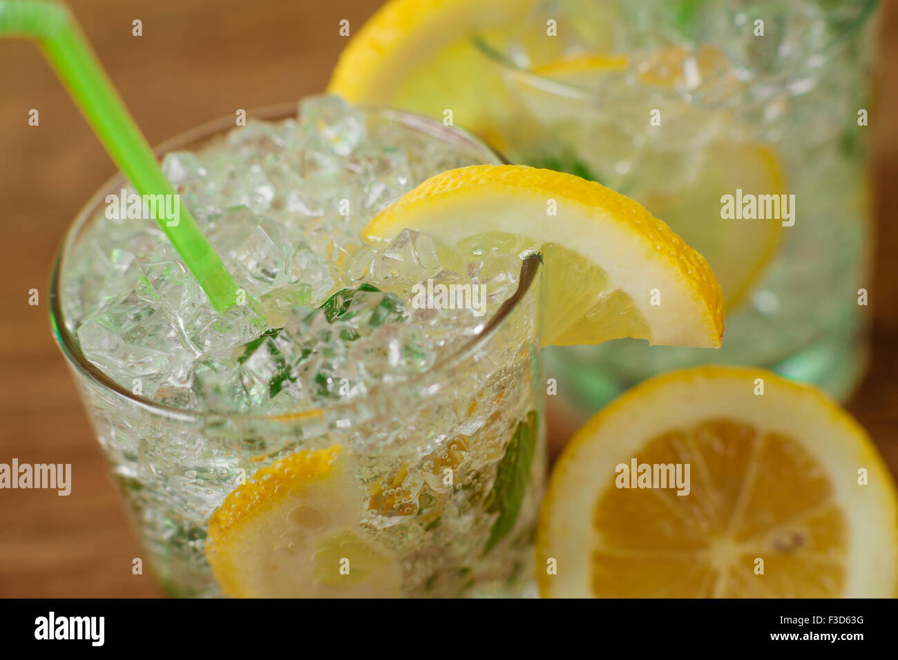 Lemonade with fresh lemon and mint by lemon reamer Stock Photo - Alamy