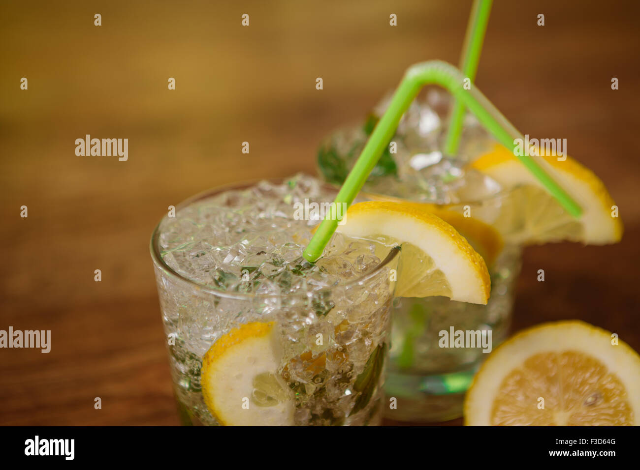 Lemonade with fresh lemon and mint by lemon reamer Stock Photo - Alamy