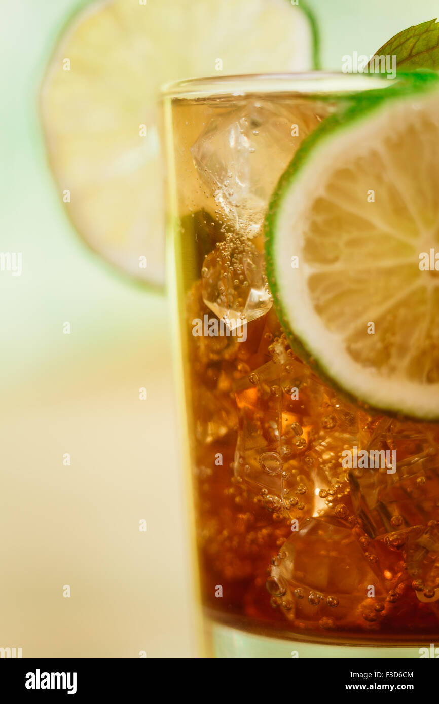 drink concept - cocktail with cola ice cubes and lime Stock Photo - Alamy