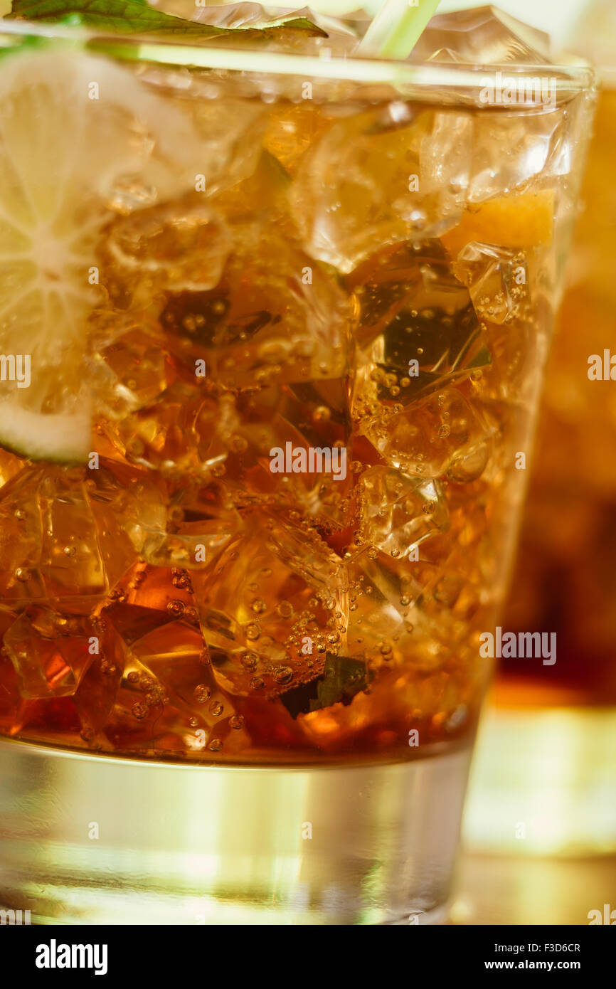 drink concept - cocktail with cola ice cubes and lime Stock Photo - Alamy